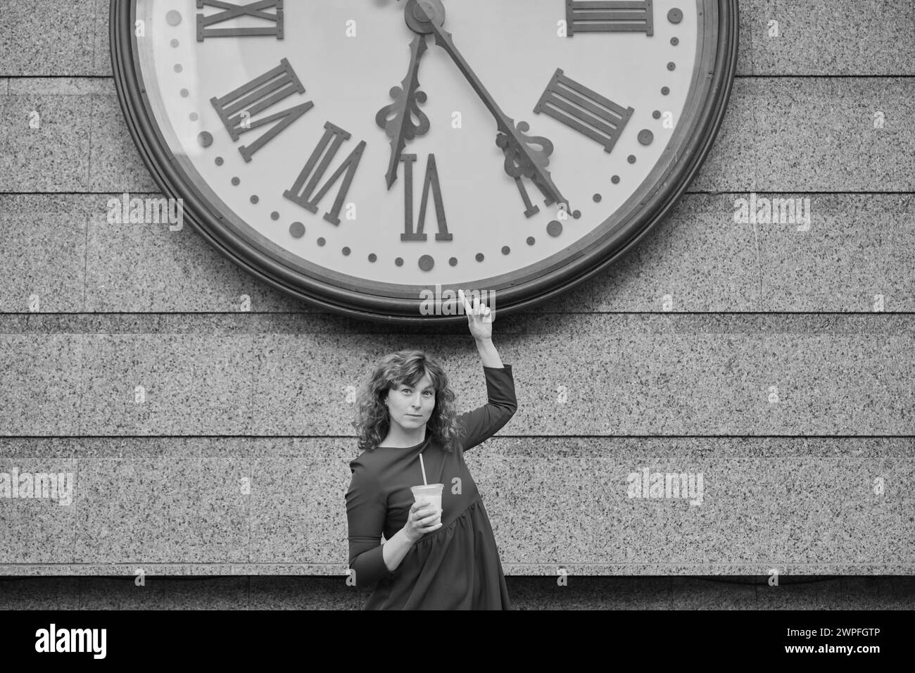 Watch the time concept. woman in dark red dress with cold tea next to ...