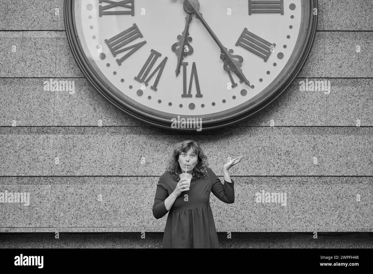 Watch the time concept. woman in dark red dress with cold tea next to ...