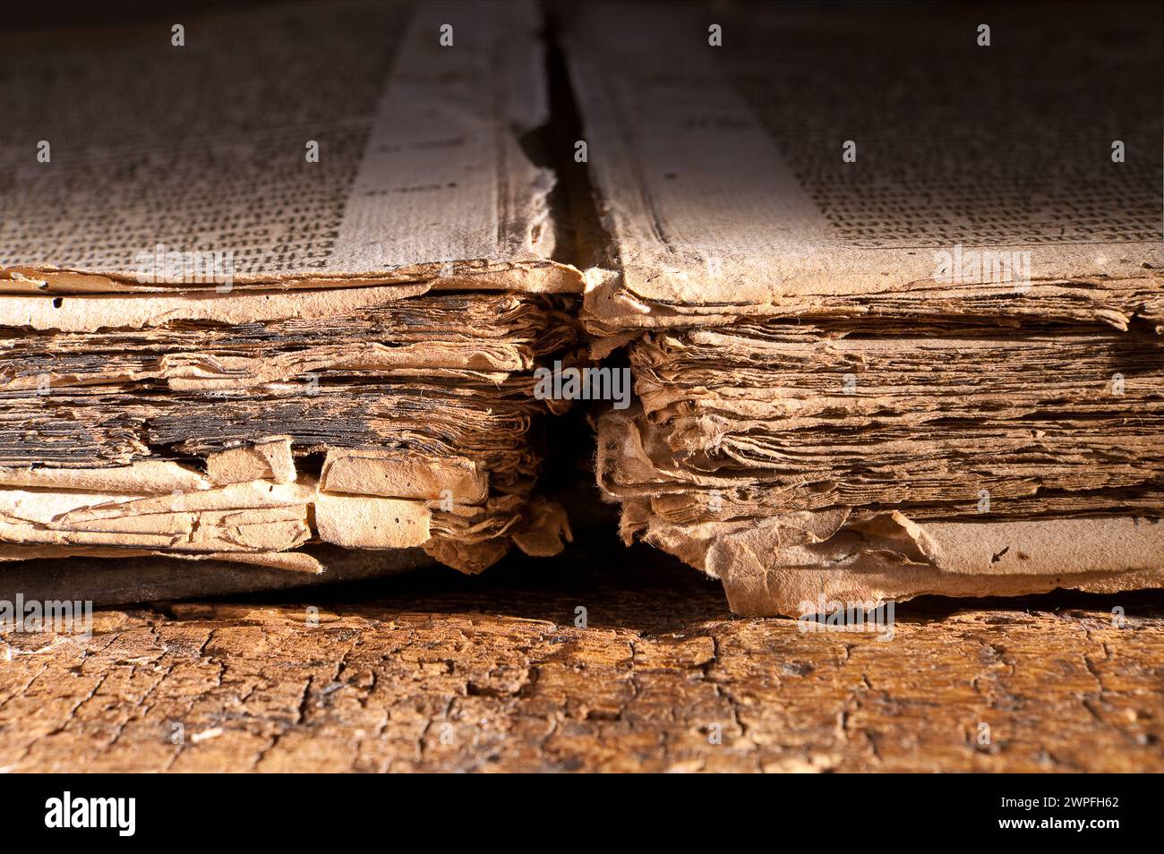 Mysterious dark view on the tattered pages of a 300 years old antique ...