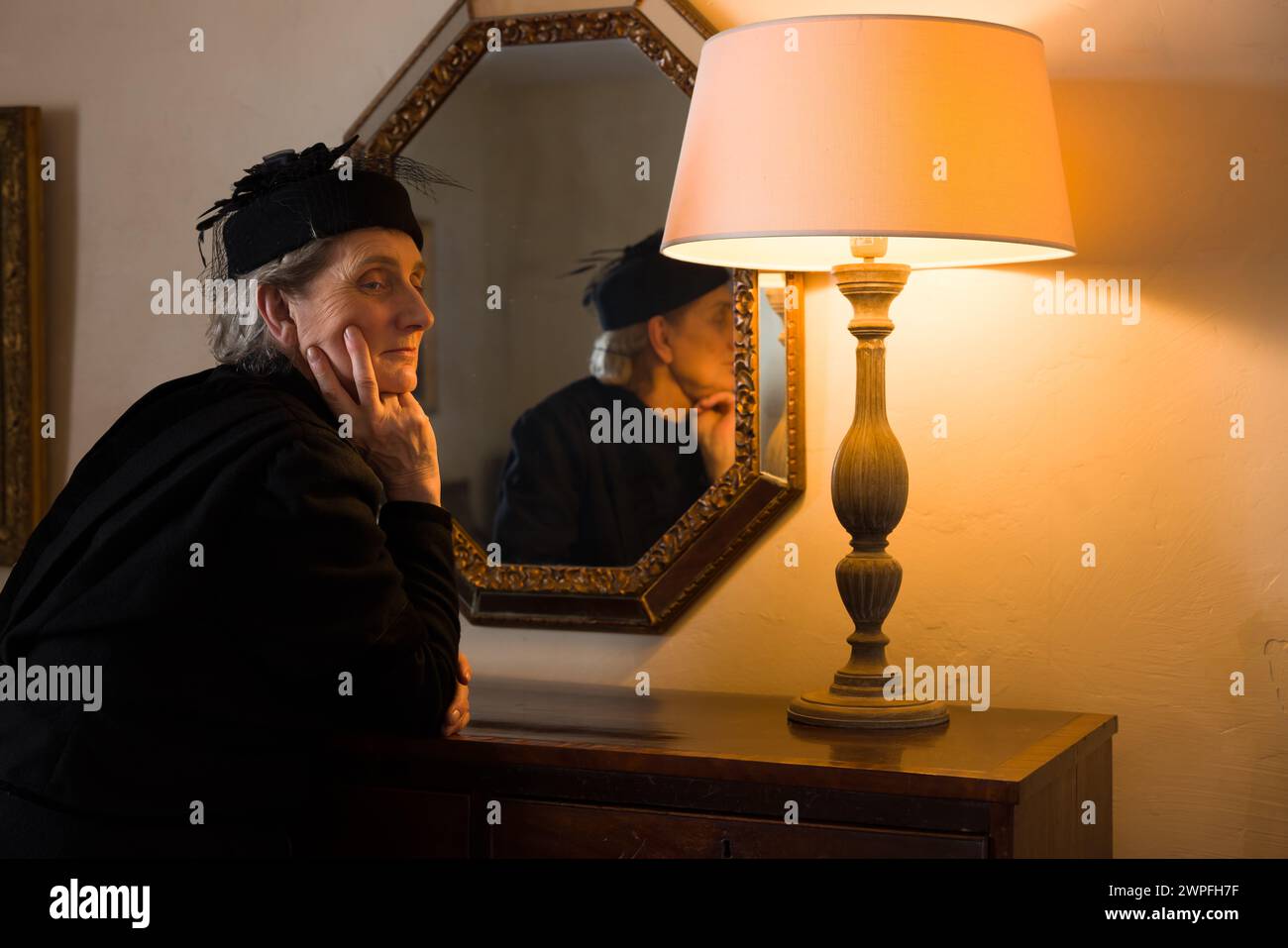 Portrait of a widow dressed in authentic Victorian dress and matching ...