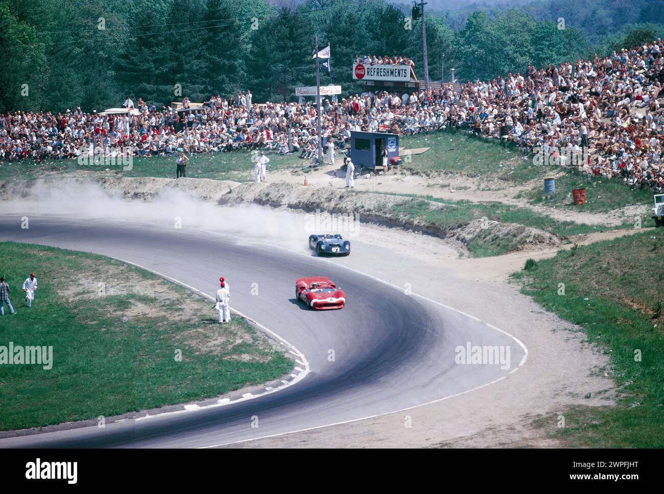 Bruce McLaren in a McLaren Elva Mark II B and John Cordts in a McLaren ...