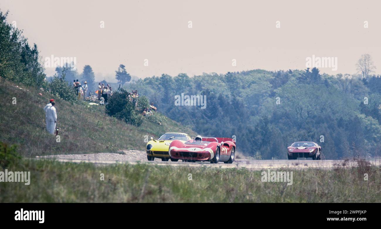 Bruce McLaren in a McLaren Elva Mark II B ahead of two other cars on ...
