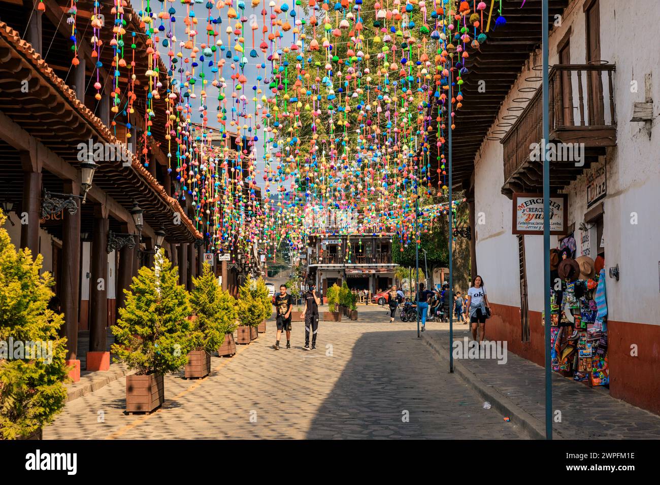 Vibrant street decorations and bustling crowds in a festive setting ...