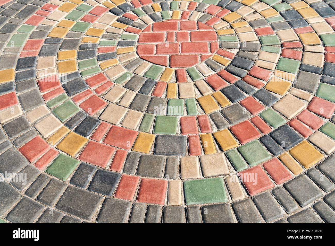 Round colorful pavement on sunny day in public park. Colorful paving ...