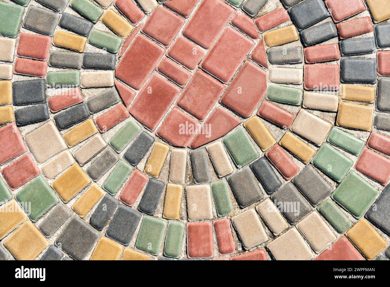 Round colorful pavement on sunny day in public park. Colorful paving ...