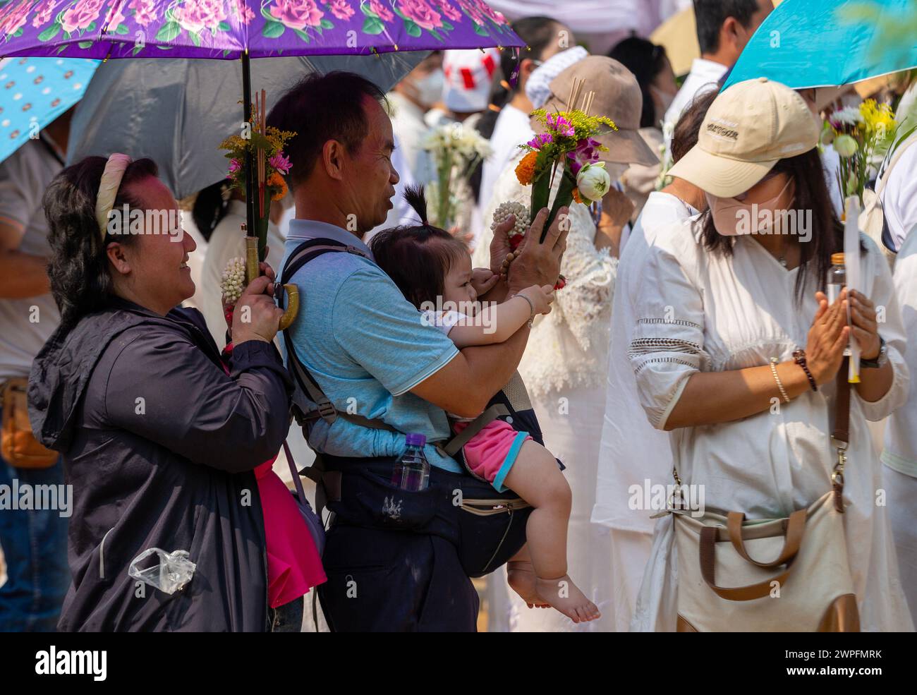 Buddhist faithful and a kid pay obeisance to the sacred relics of Lord ...