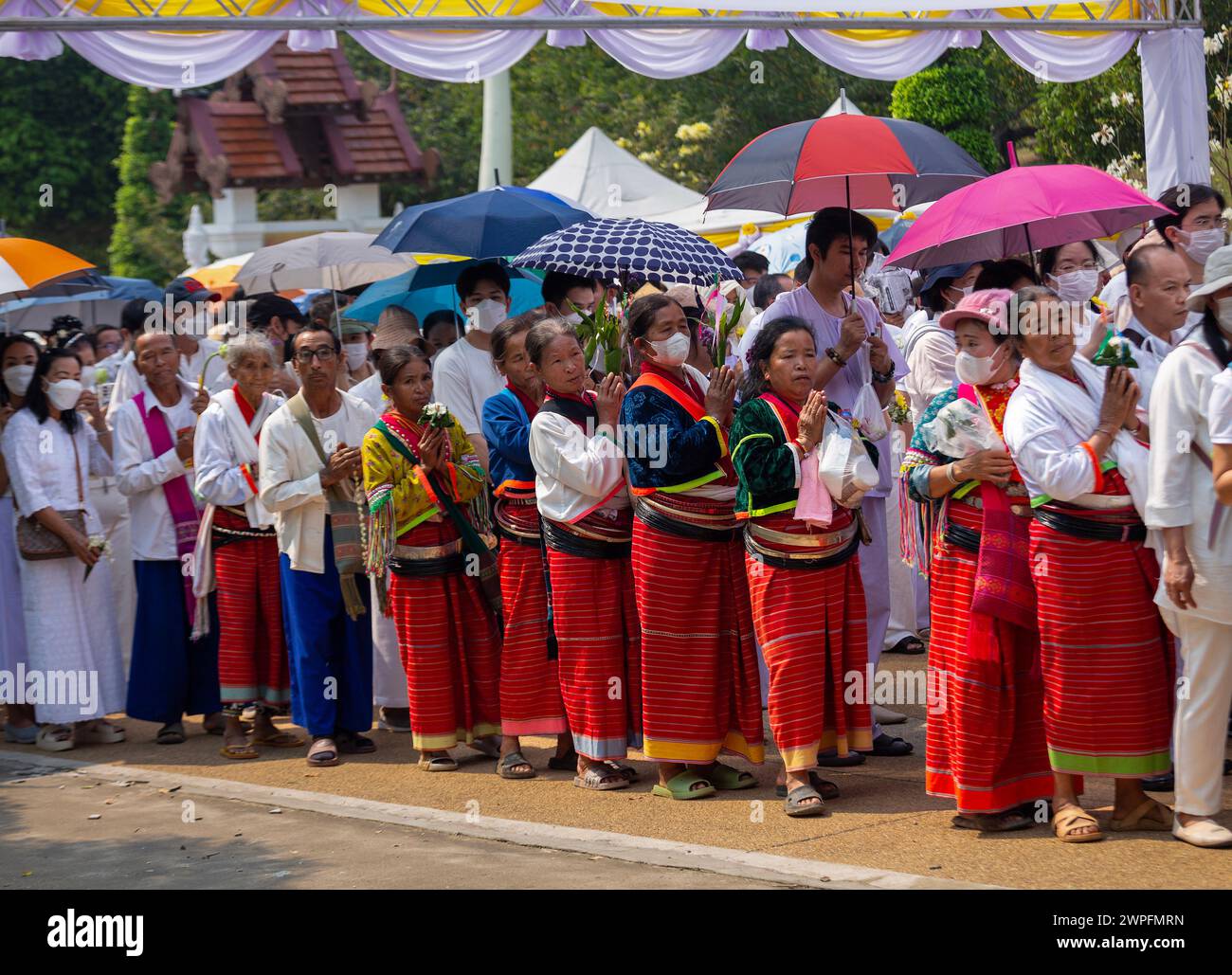 Women from the ethnic hill tribe wearing traditional clothing pay ...