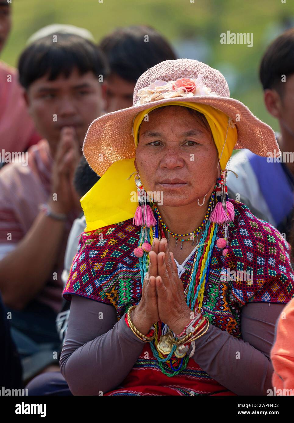 Woman from the ethnic hill tribe wearing traditional clothing pays ...