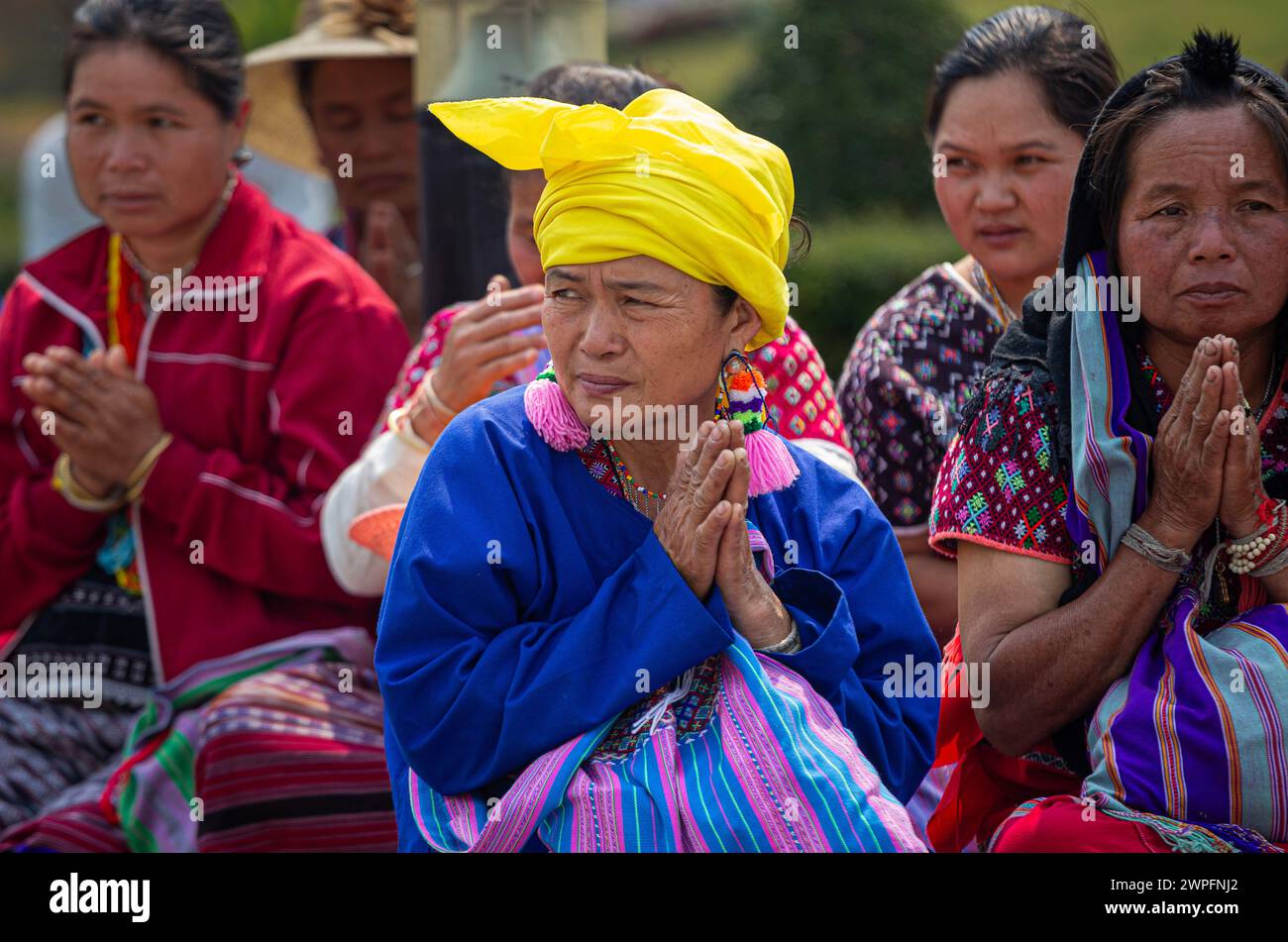 Women from the ethnic hill tribe wearing traditional clothing pay ...