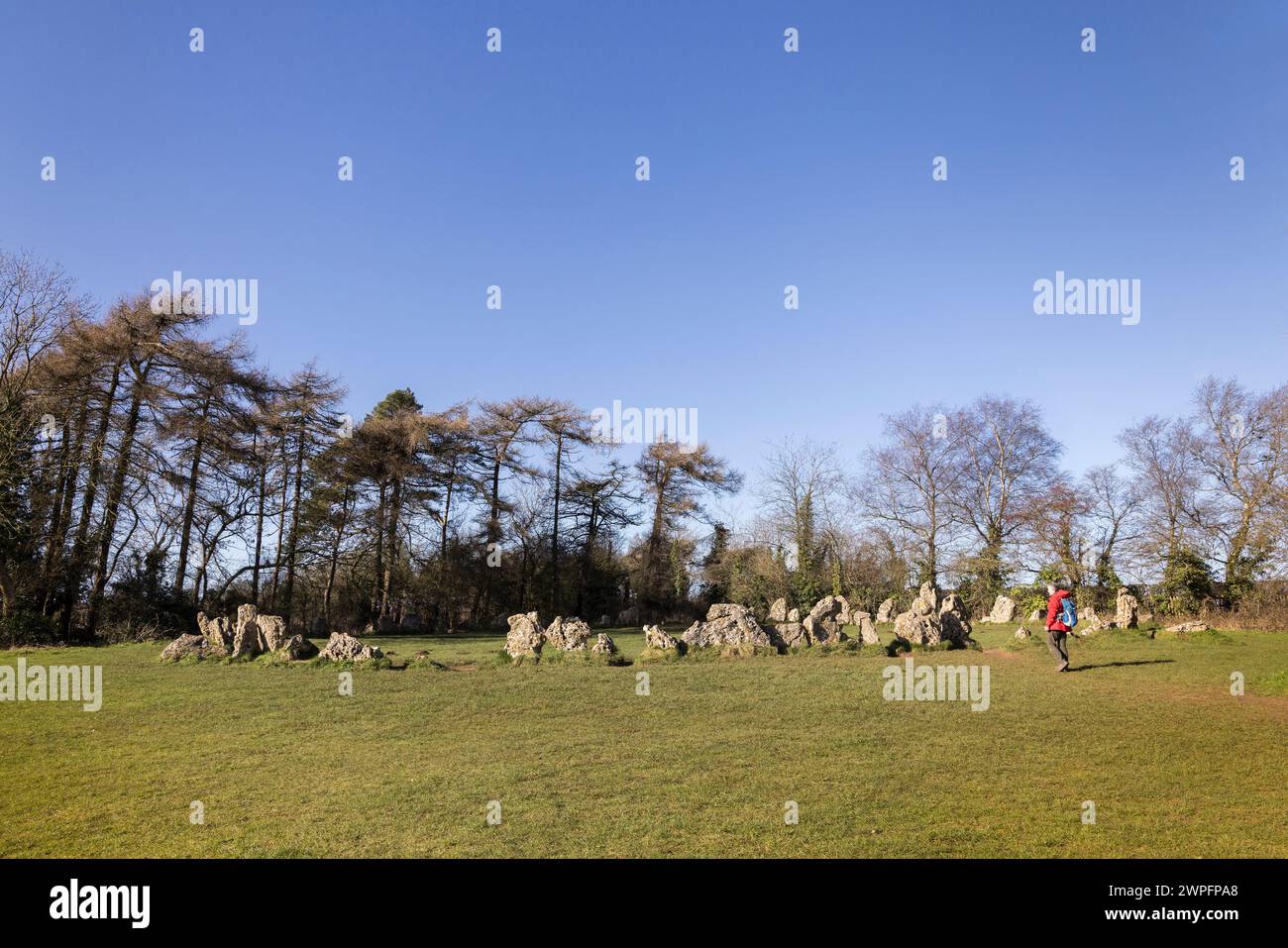 Person at the Rollright Stones prehistoric stone circle on the border ...