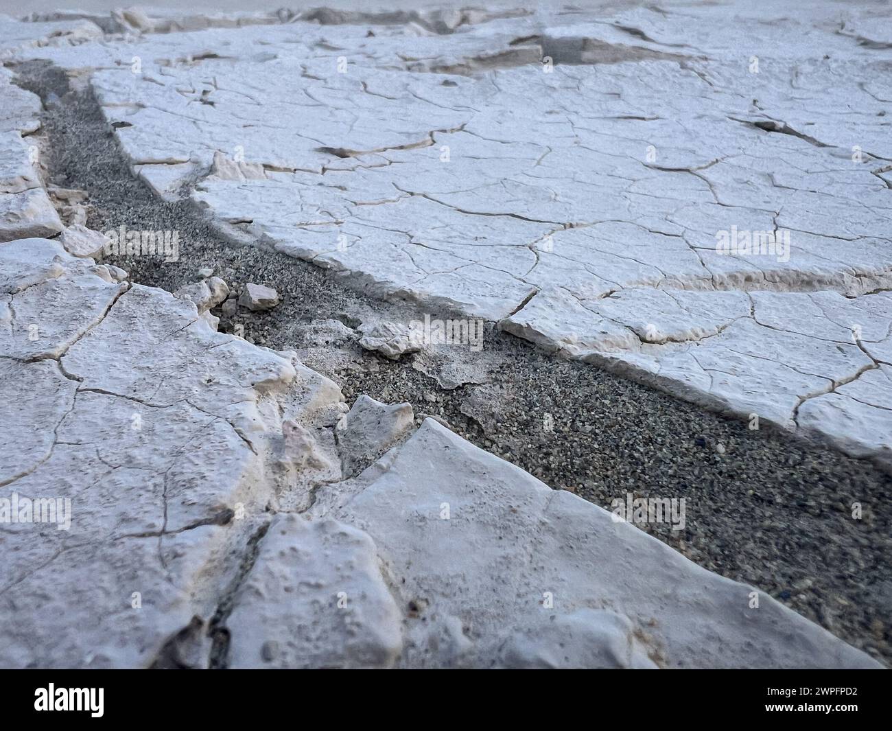 The Dried and cracked mud at Mesquite Flat Sand Dunes in Death Valley ...