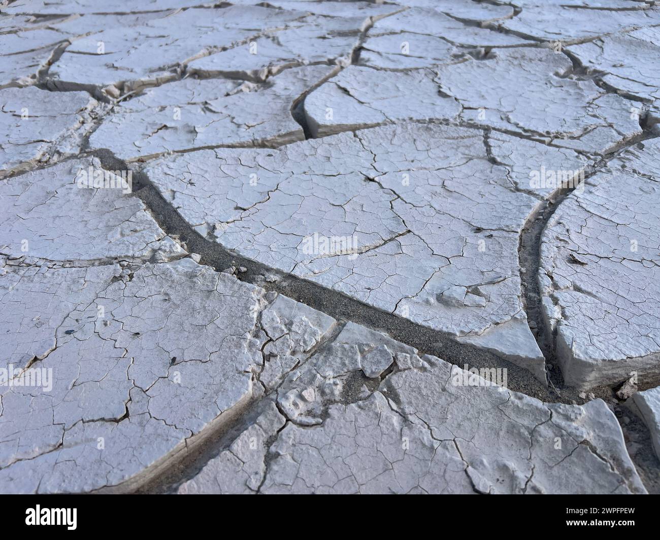 The Dried and cracked mud at Mesquite Flat Sand Dunes in Death Valley ...