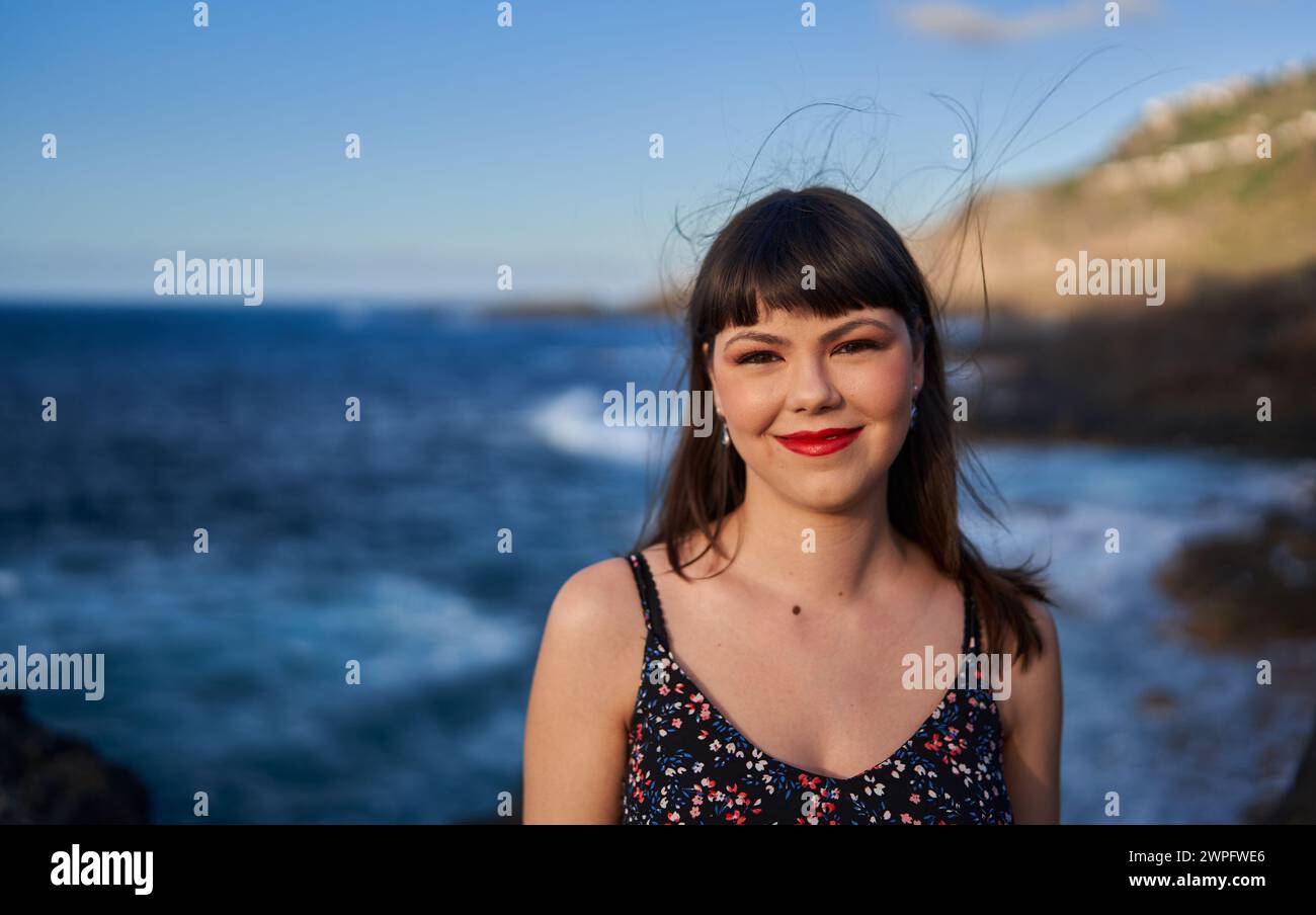 Holiday in Tenerife - portrait of a beautiful young woman by the ocean ...