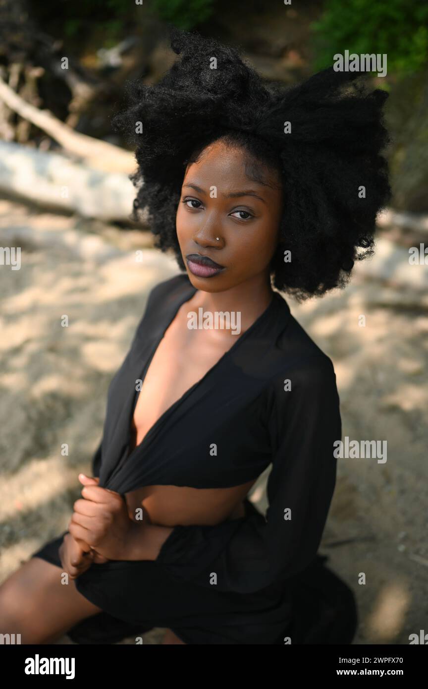 Fashion outdoor beach portrait Beautiful young African American Black woman posing outside on ...