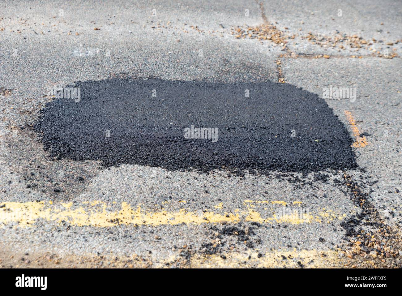 Large repaired pothole in a road in Westcliff on Sea, Essex, UK, in ...