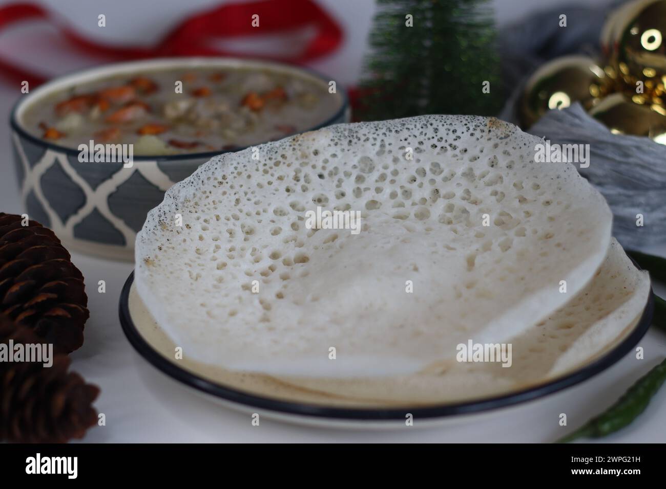 A traditional Kerala breakfast of appam and stew. Appam is a soft and ...