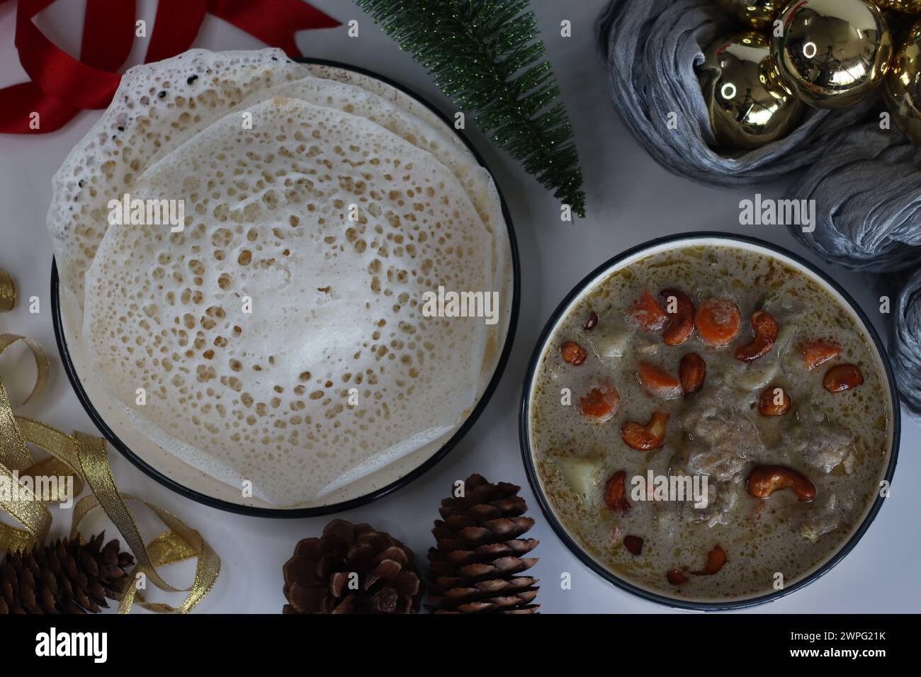A traditional Kerala breakfast of appam and stew. Appam is a soft and ...