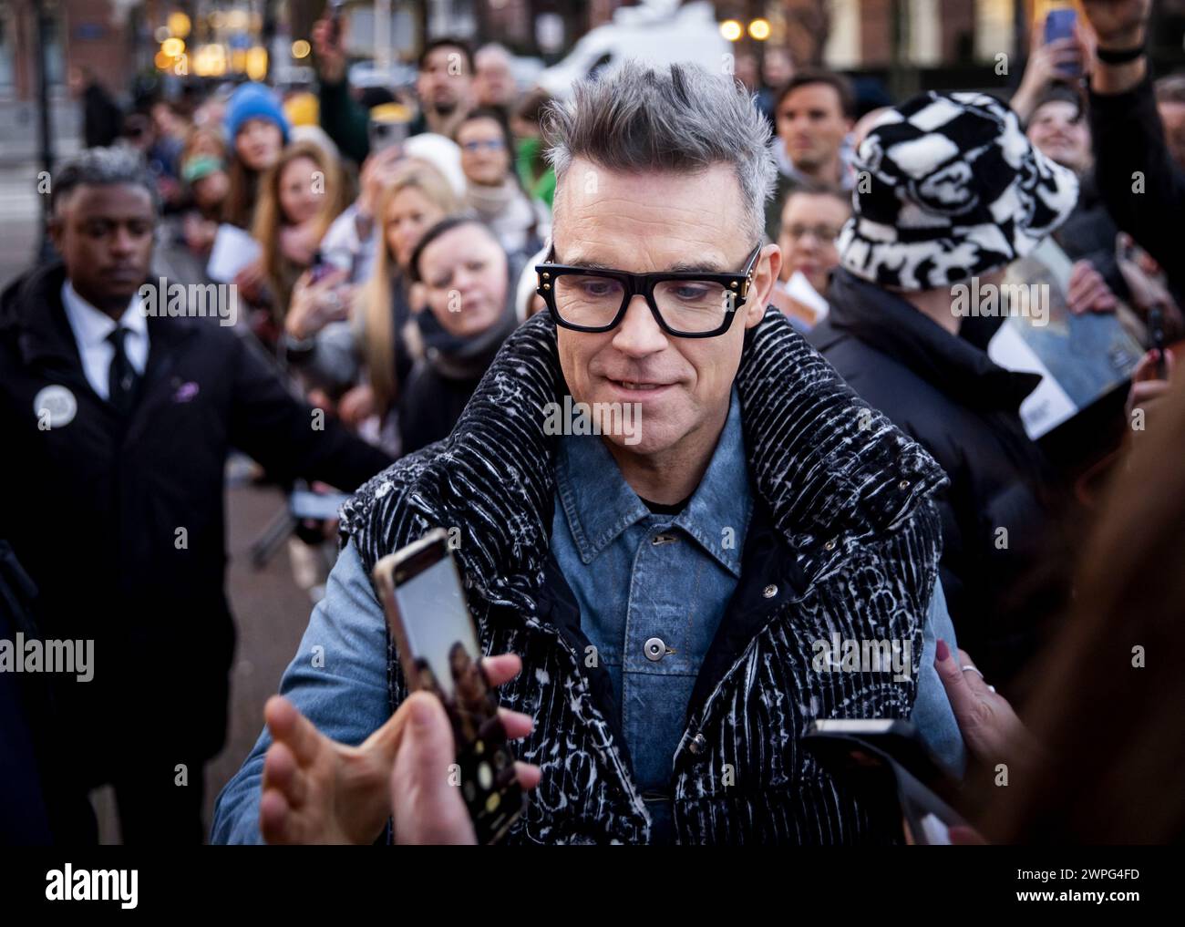 AMSTERDAM - Robbie Williams with fans prior to the opening of the ...