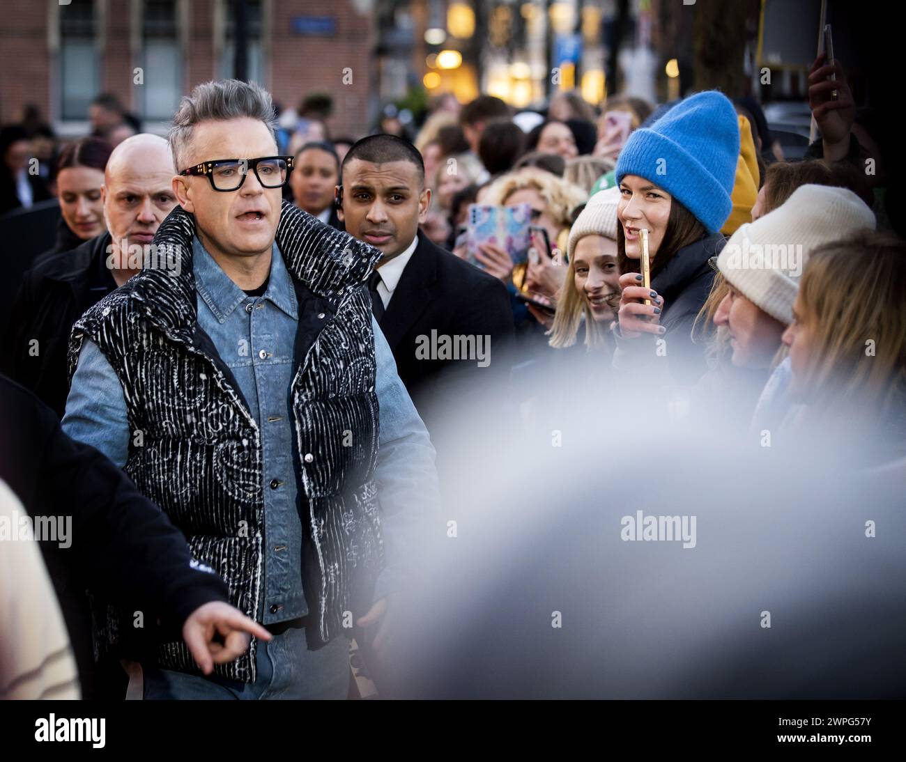 AMSTERDAM - Robbie Williams with fans prior to the opening of the ...