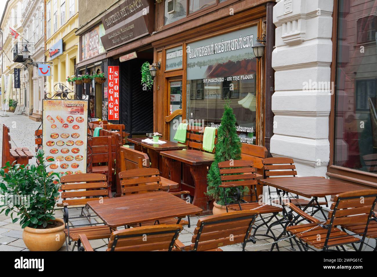 Bratislava, Slovakia Outdoor seating area with wooden chairs and tables ...