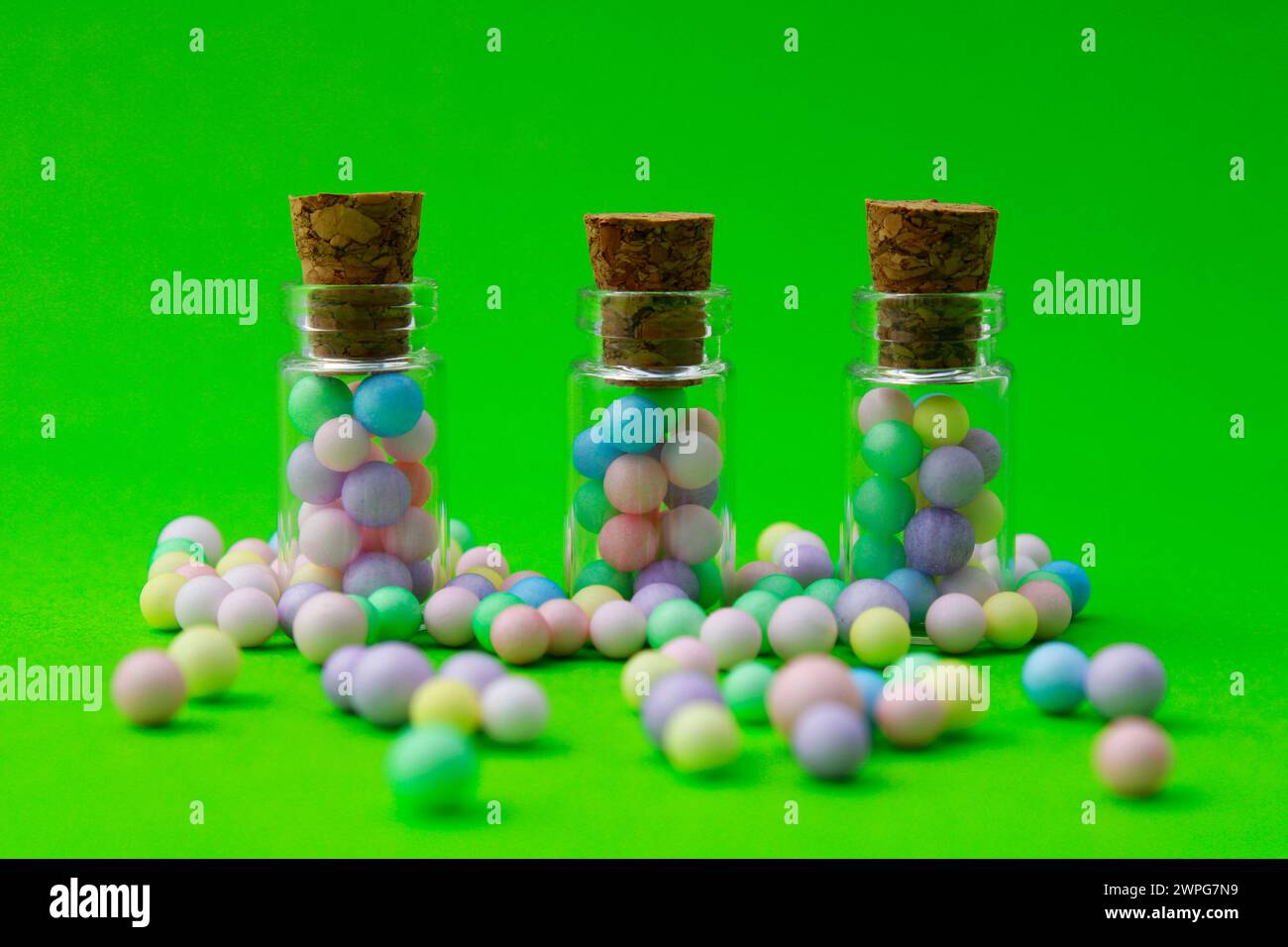 Three glass jars with colorful spheres inside and outside them Stock ...