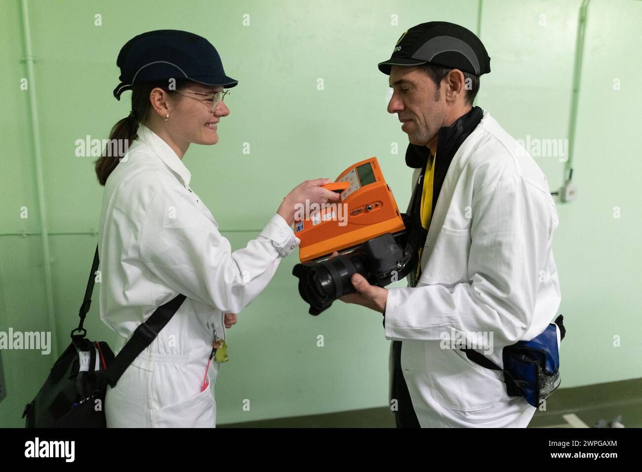 Orano employees check radiations on cameras after the visit of the ...