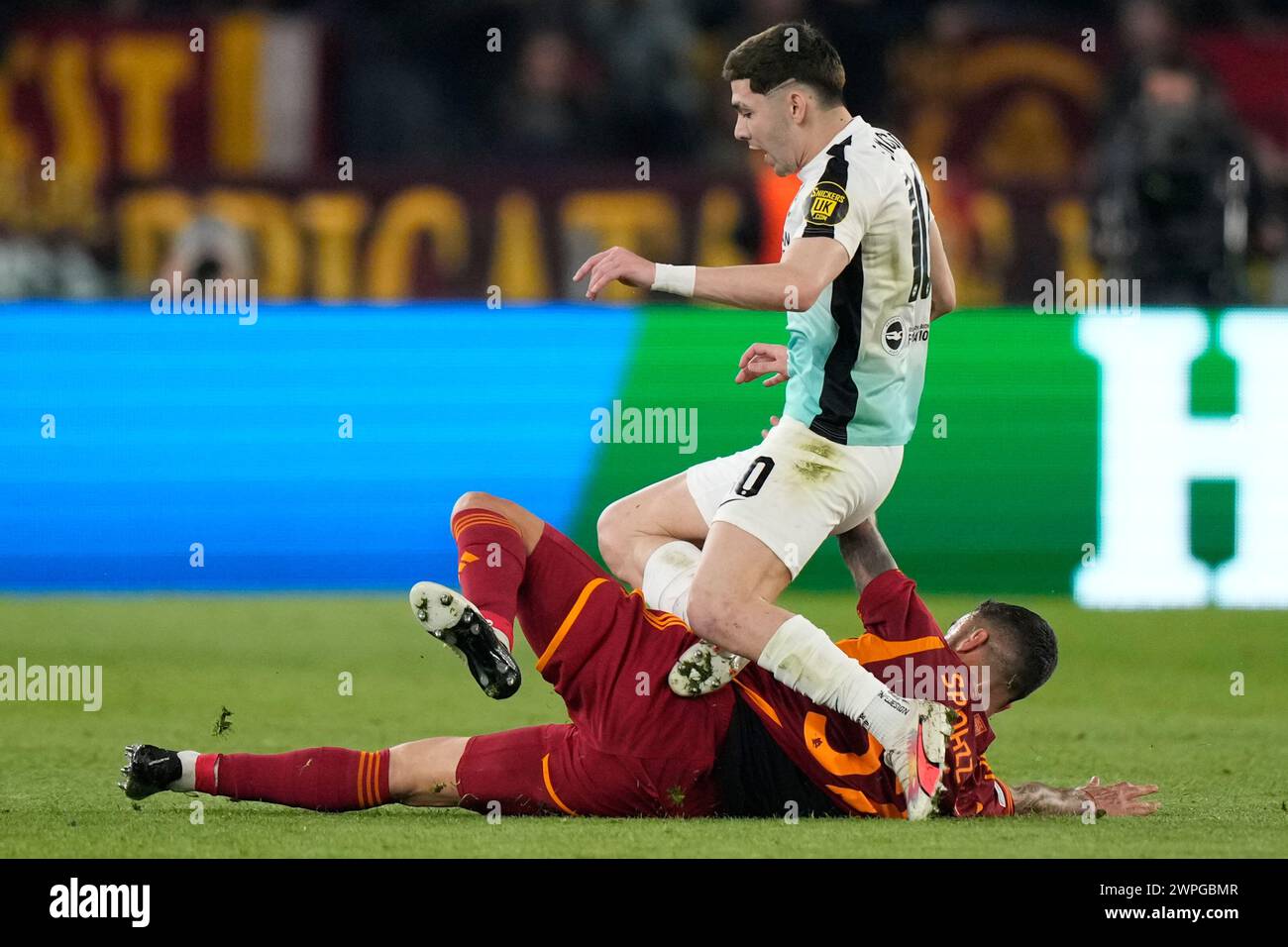 Roma's Leonardo Spinazzola, bottom, and Brighton's Julio Enciso compete ...