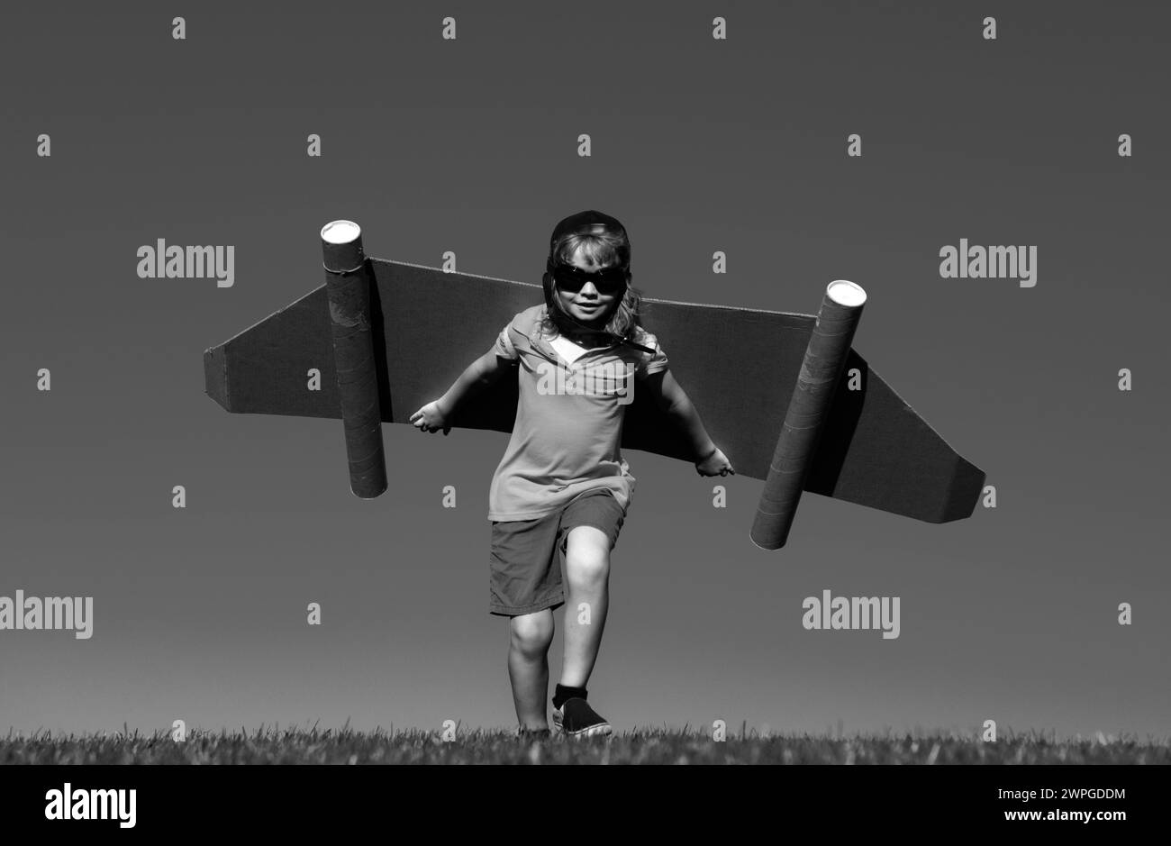 Kid with jet pack superhero. Child pilot against summer sky background ...