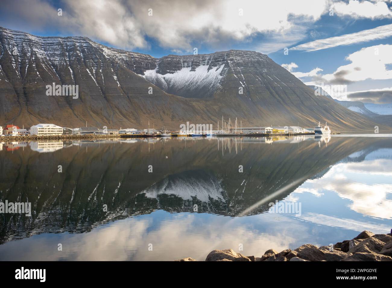 Cloudy sky reflection in the calm water of Atlantic ocean in the fjord ...