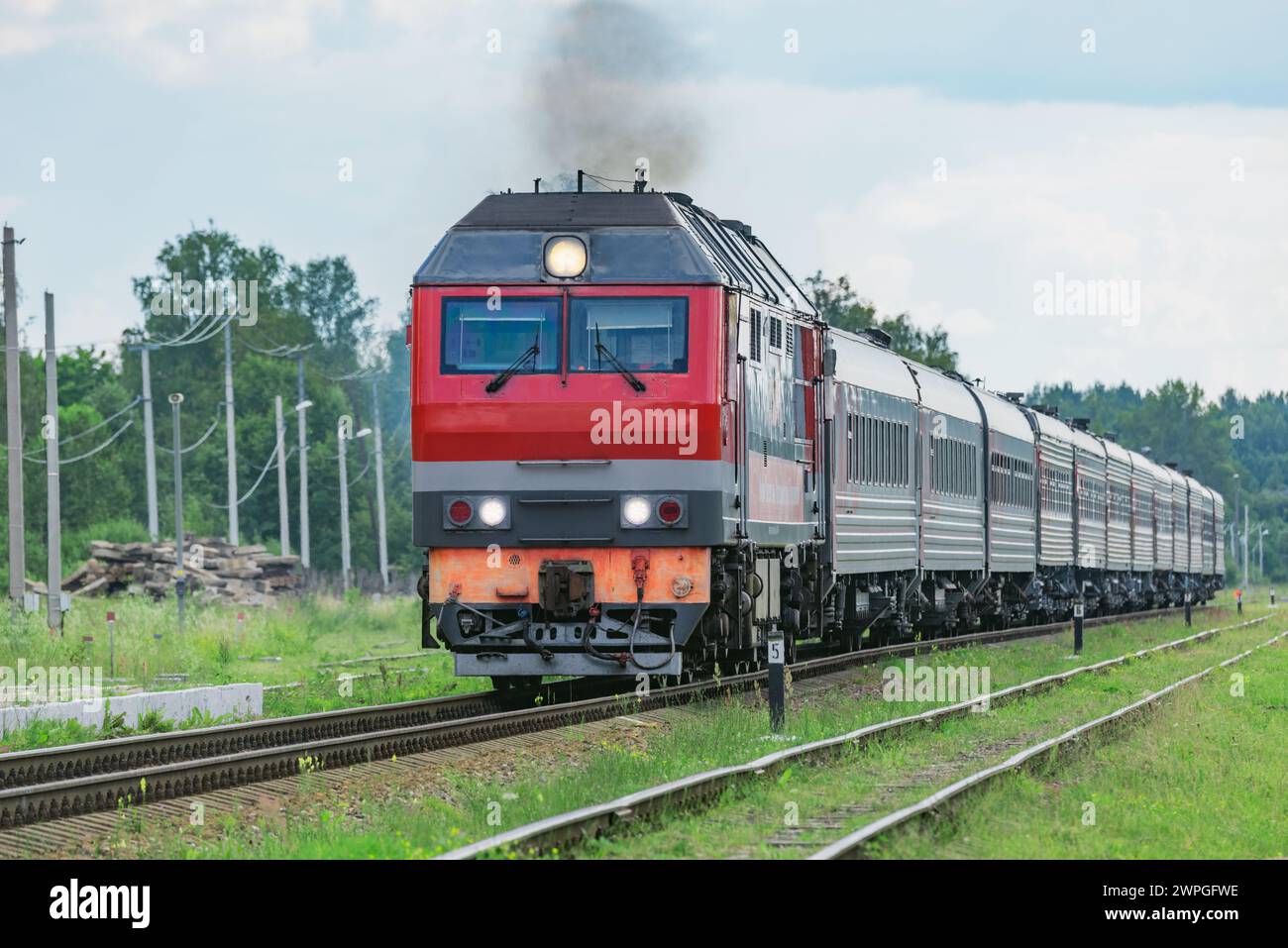 Passenger train approaches to the platform Stock Photo - Alamy