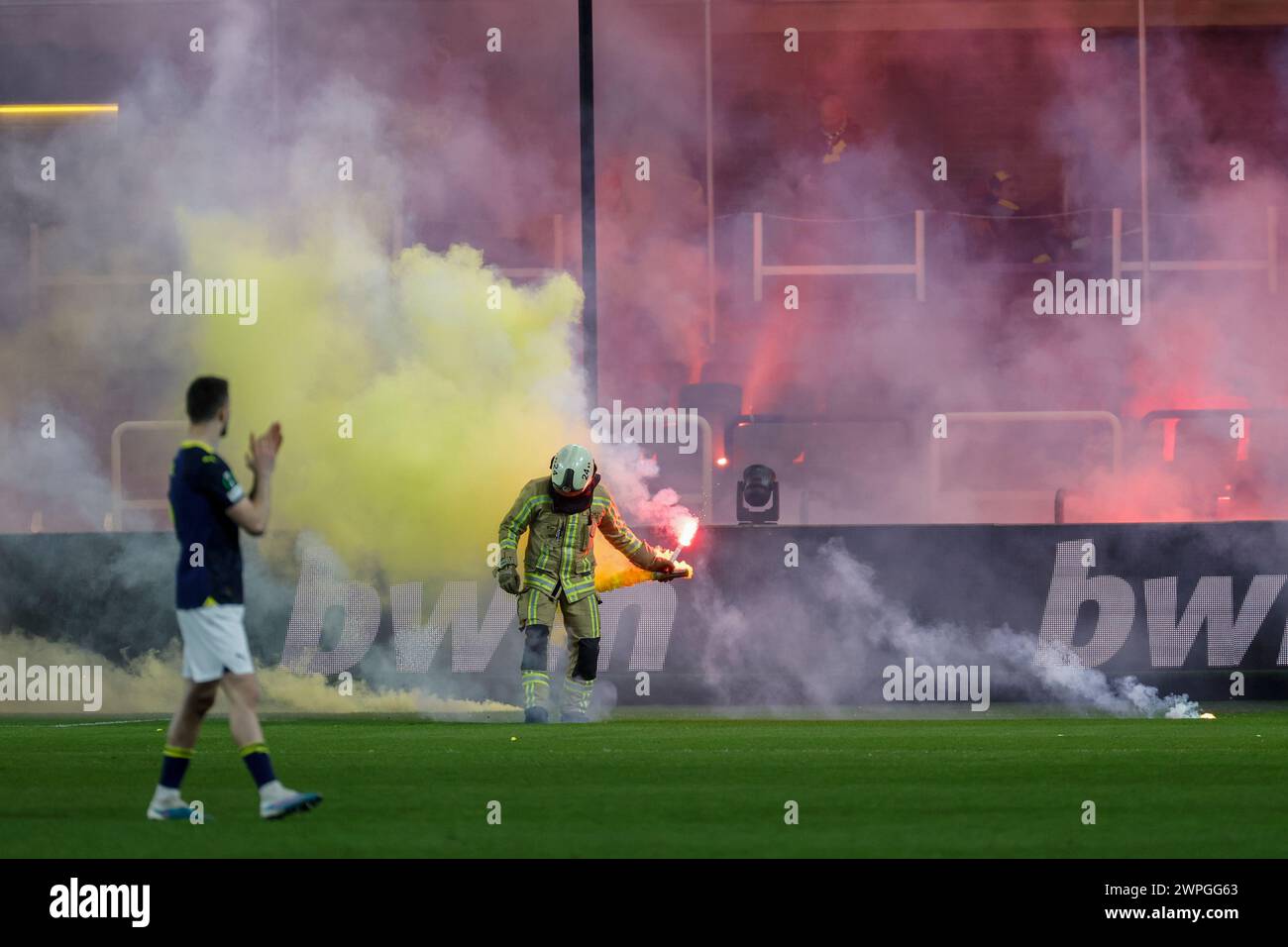 A firefighter removes a flare ahead the Europa Conference League round ...