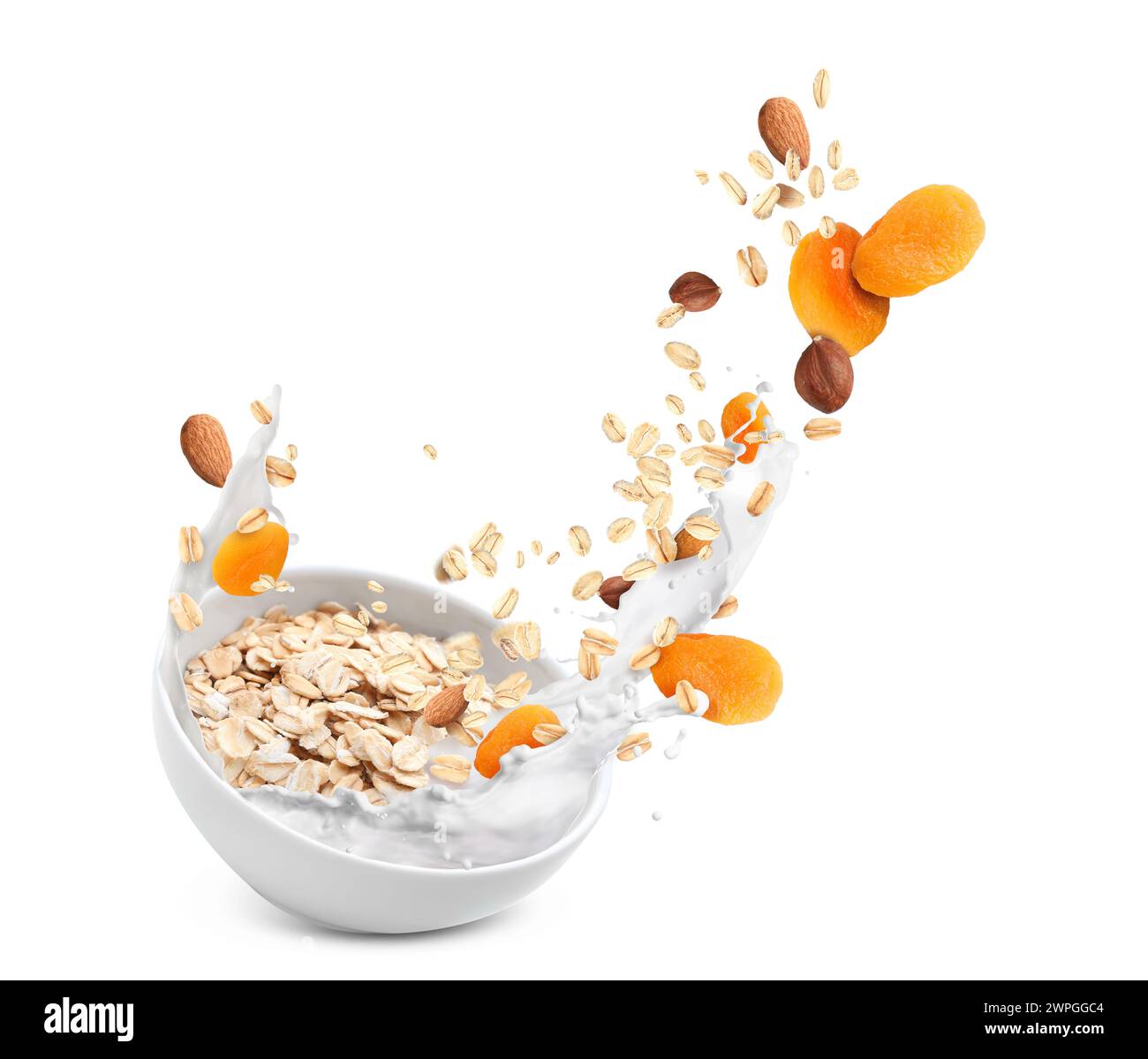 Bowl with splashes of milk, flying rolled oats, nuts and dried apricots ... Bowl with splashes of milk, flying rolled oats, nuts and dried apricots ...
