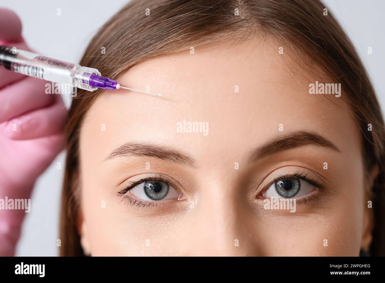 Beautiful woman receiving injection on light background, closeup Stock ...