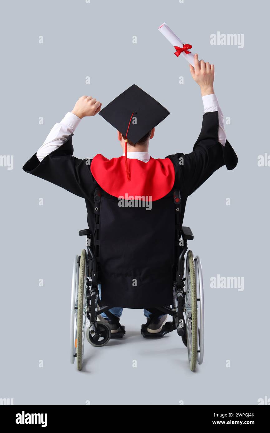 Male graduate in wheelchair with diploma on light background, back view ...