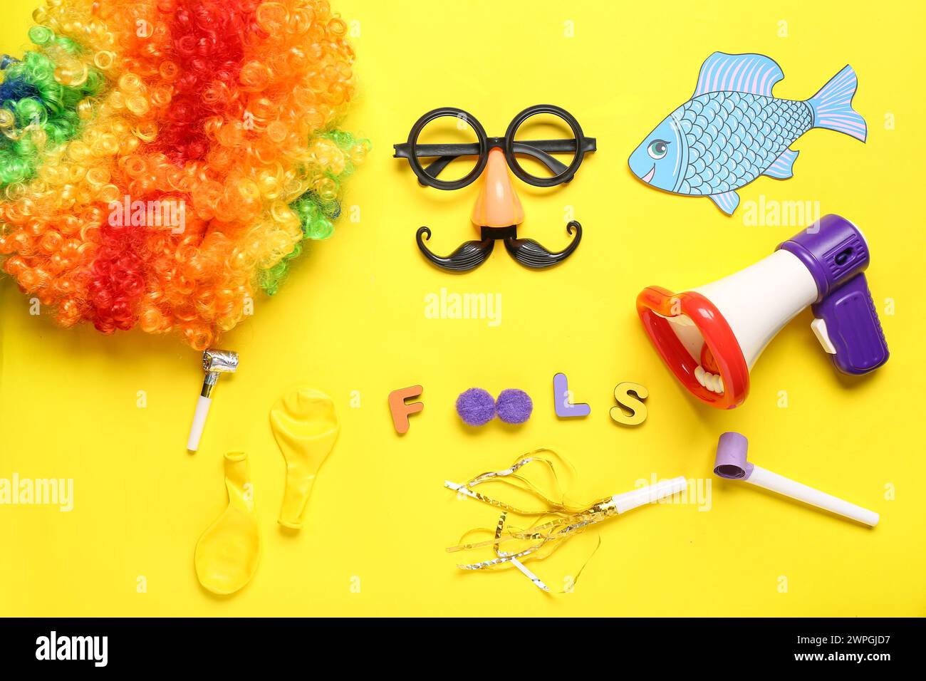Word FOOLS with funny glasses, party decor and megaphone on yellow ...
