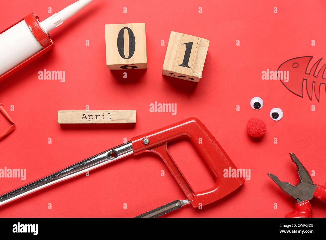 Calendar with mechanic tools, paper fish and decor on red background ...