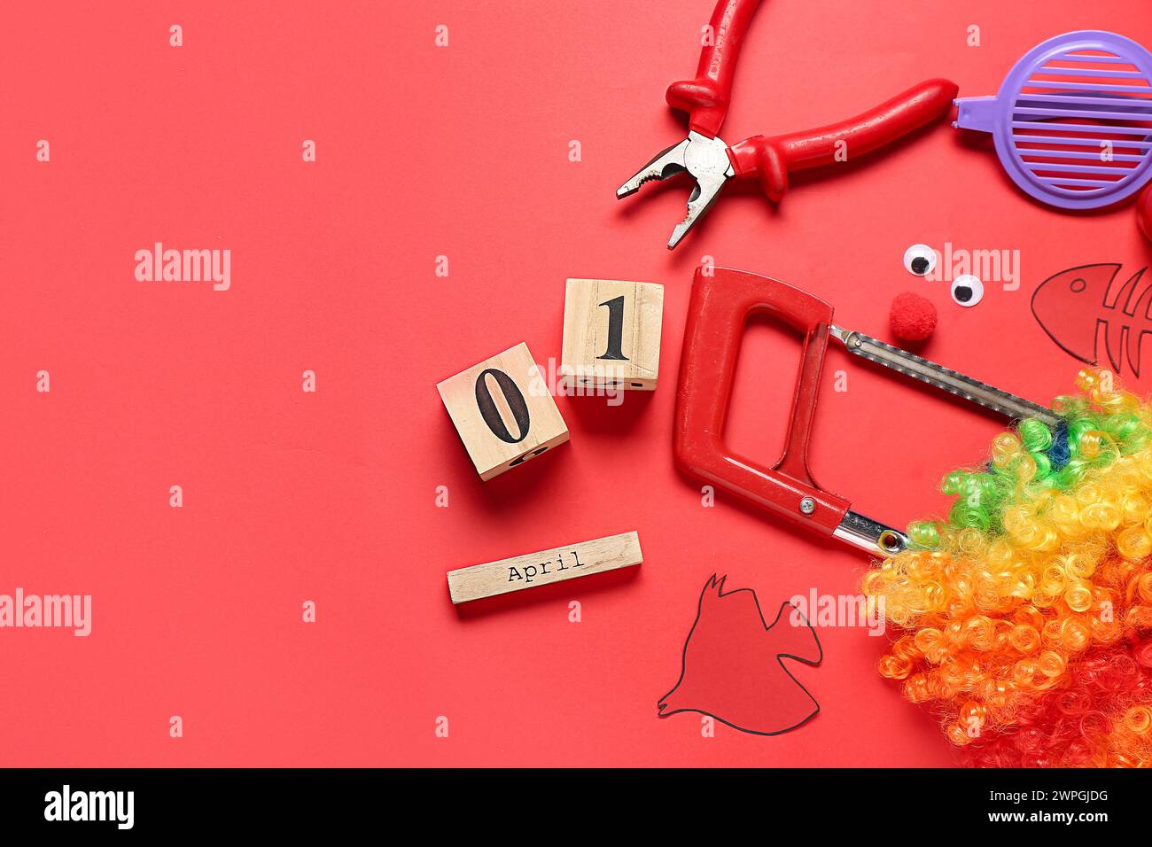 Calendar with mechanic tools, clown wig and decor on red background ...