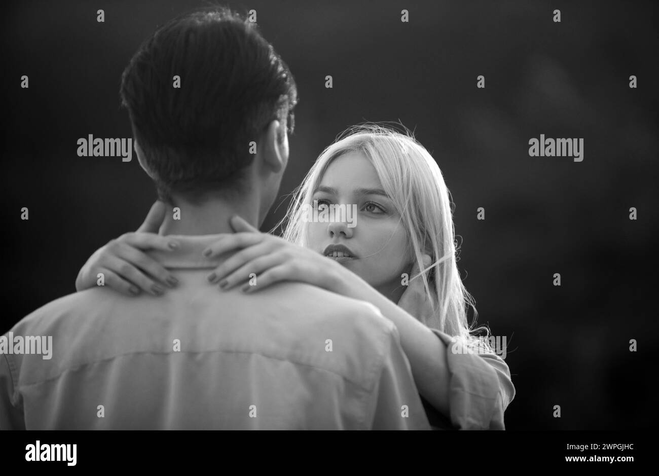 Couple lovers hugging and kissing at sunset. Young couple in love spends time together. Man ...