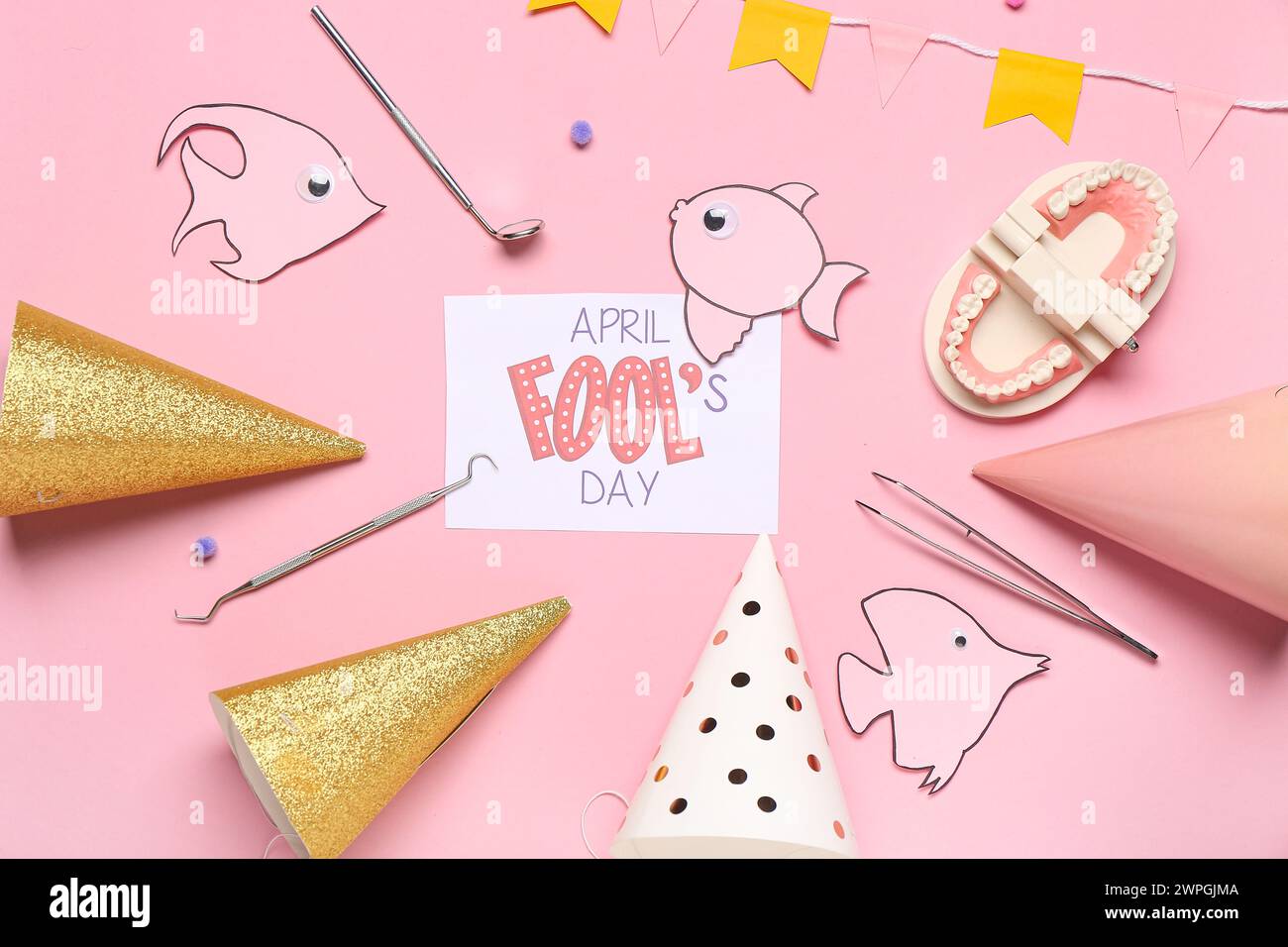 Paper fishes with April Fool's Day card, party decor and dentist tools ...