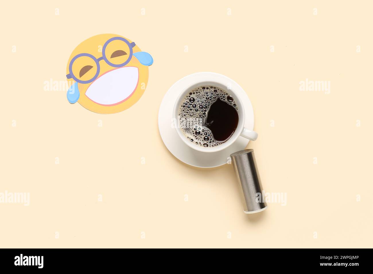 Cup of coffee with salt shaker on beige background. April Fools Day ...