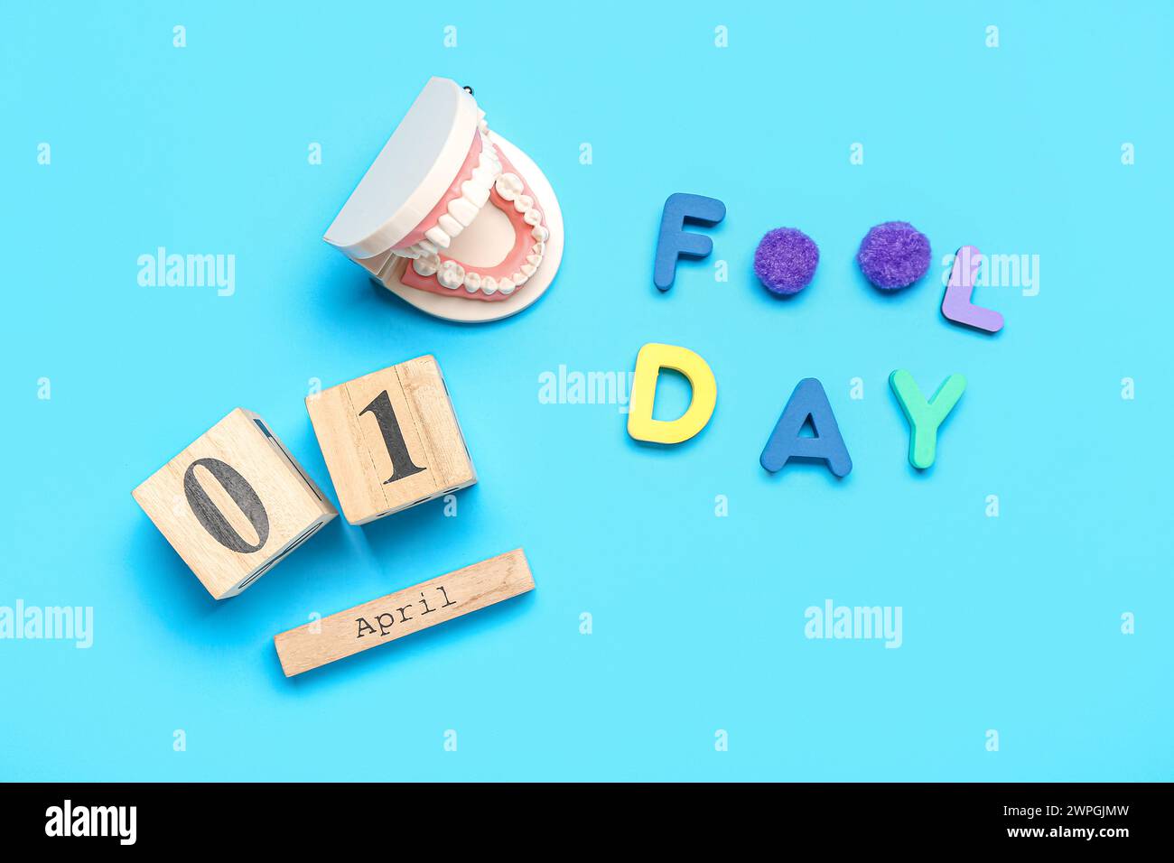 Calendar with text FOOL DAY and model of jaw on blue background Stock ...