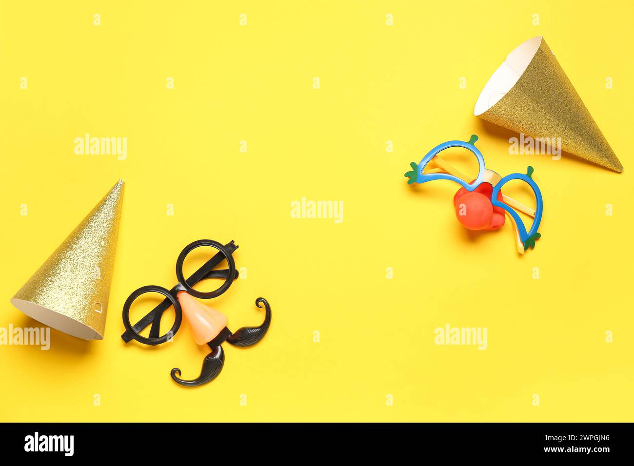 Funny glasses with party hats on yellow background. April Fools Day ...