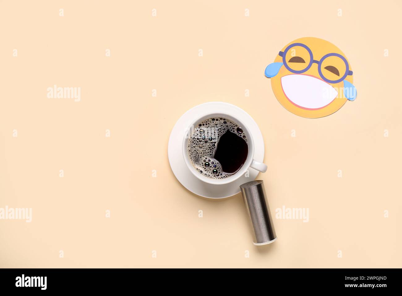 Cup of coffee with salt shaker on beige background. April Fools Day ...