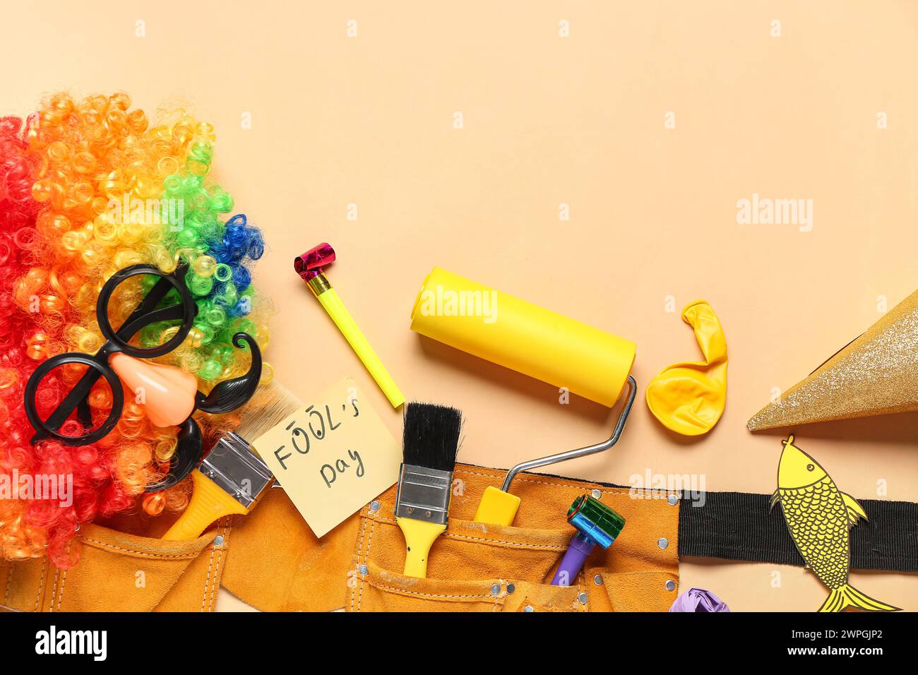 Construction tools with sticky note and party decor on beige background ...