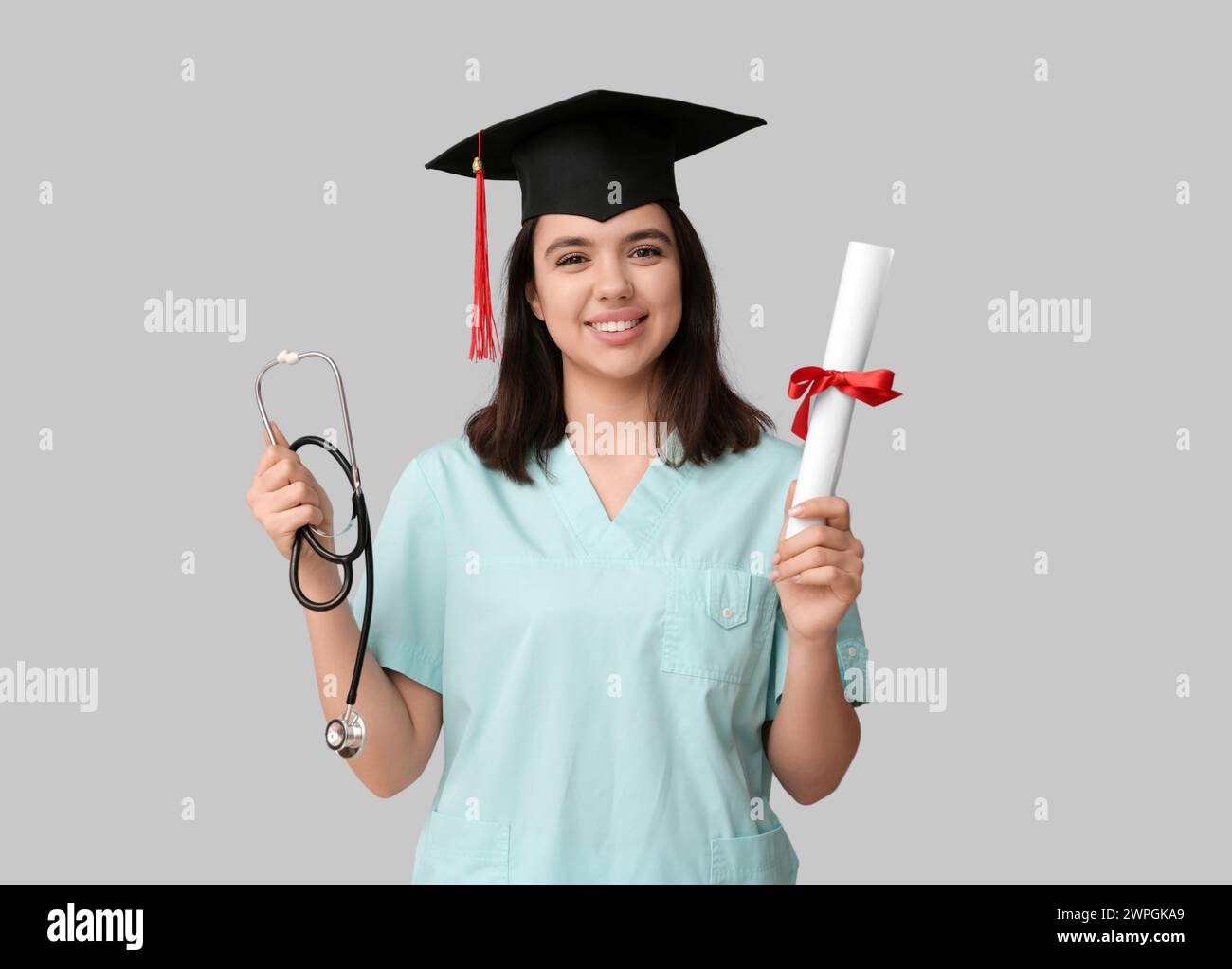 Happy female medical student in graduation hat with stethoscope and ...
