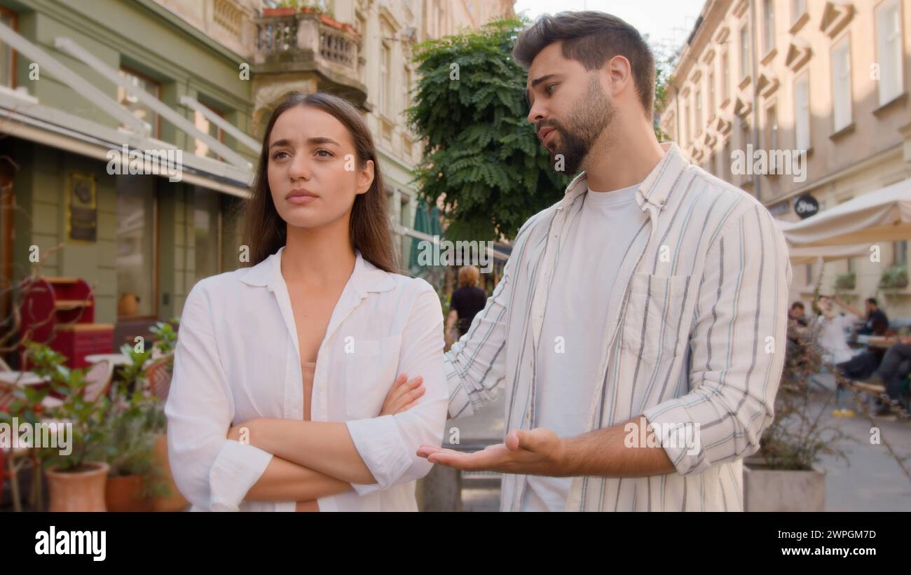 Young couple city annoyed offended angry woman arms crossed guilty man ...