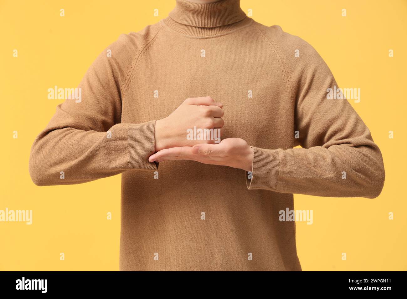 Young deaf mute man using sign language on yellow background Stock ...