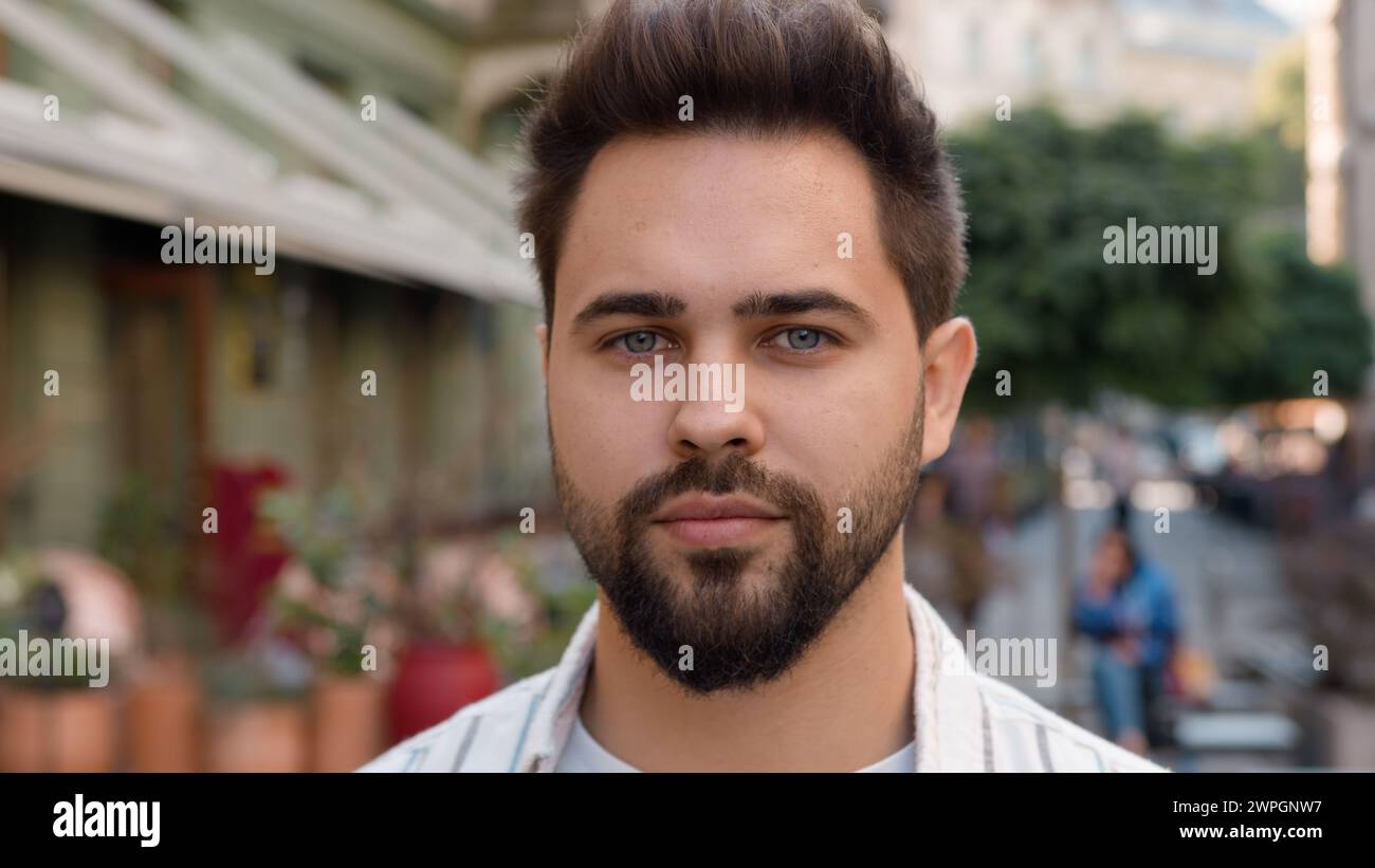 Close up portrait European Caucasian young man looking at camera ...