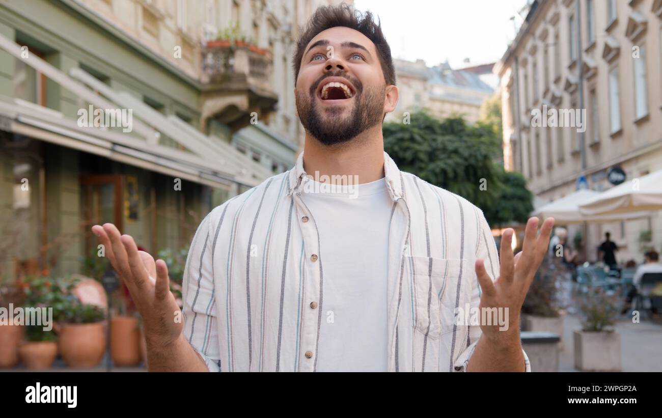 Young Caucasian European man rejoice gesturing smiling victory success ...