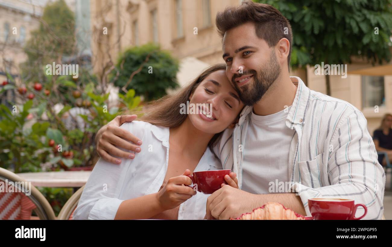 Happy young couple woman boyfriend Caucasian man kissing girlfriend ...